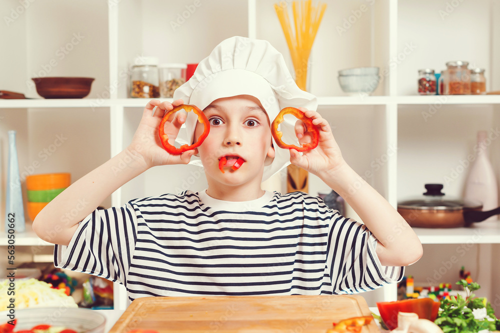 Chef boy at cooking classes. Cute little chef having fun at kitchen ...