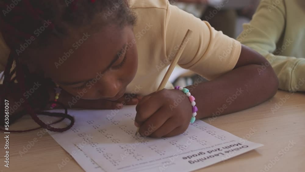 Two elementary school kids of African American ethnicity doing Math ...