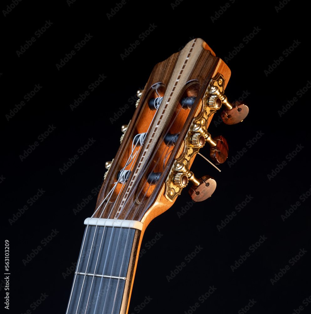 Classical guitar headstock detail isolated on black background. Classic ...
