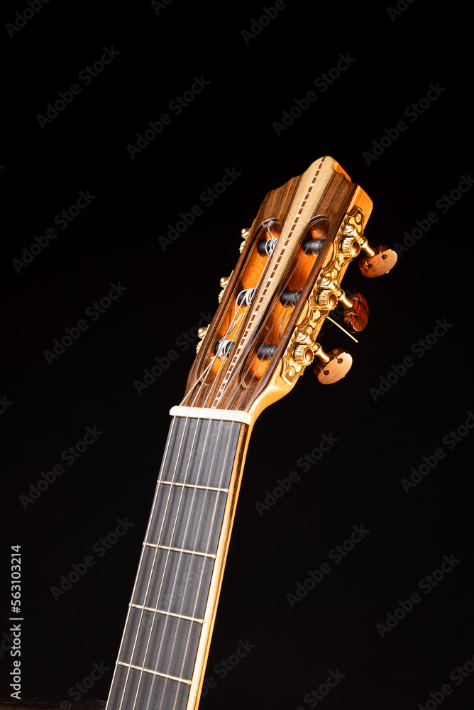 Classical guitar headstock detail isolated on black background. Classic ...
