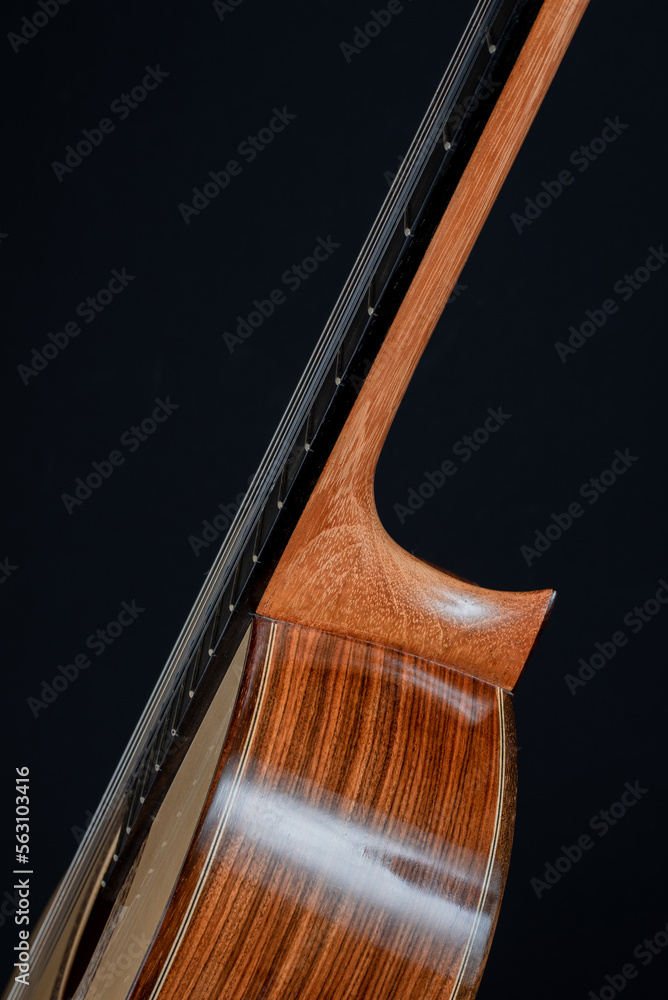 Classical guitar side isolated on black background, view from the side ...