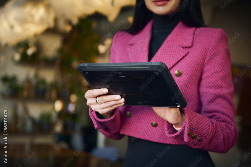 Cropped view with focus on electronic gadget. Successful businesswoman ...
