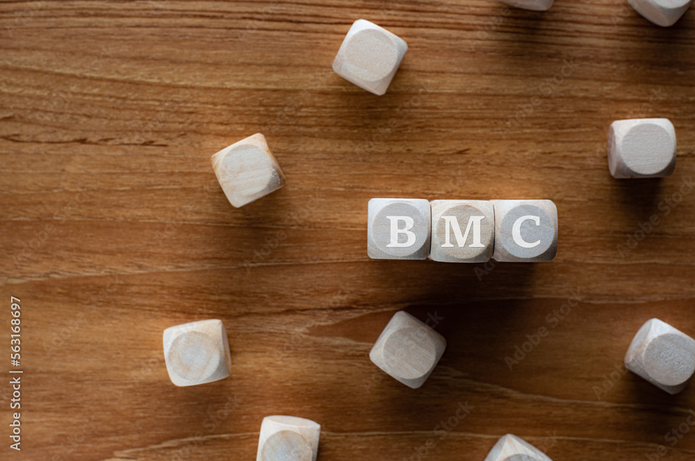 There is wood cubes with the word BMC. It's an abbreviation for Business Model Canvas. Stock ...