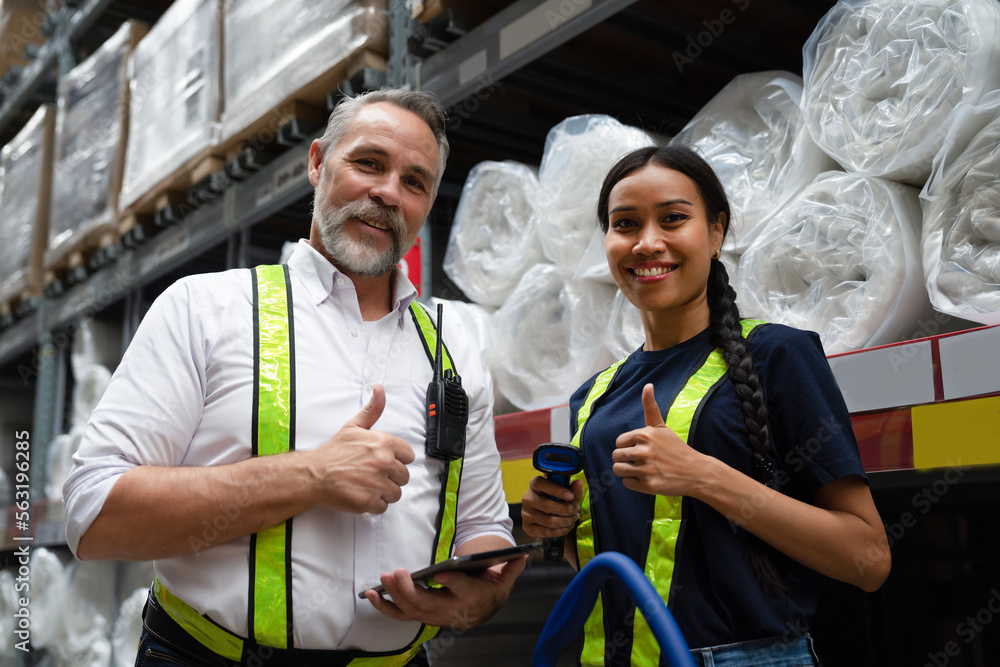Warehouse teamwork showing thumb up after successful stock annual ...