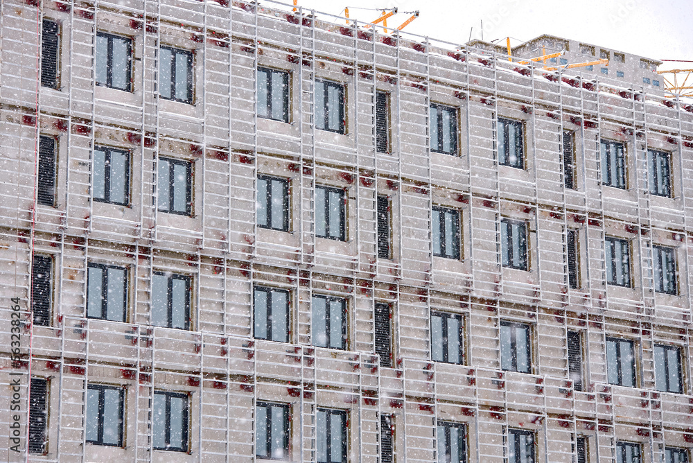Insulation of building during winter snow storm, external facade works ...