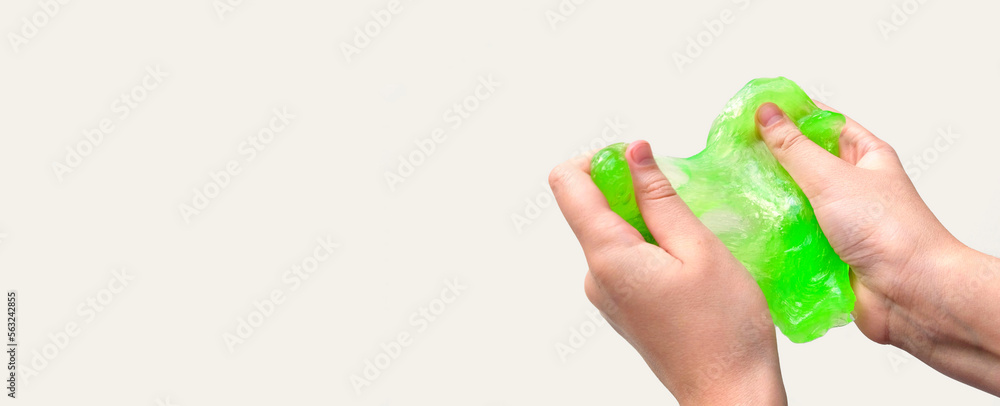 Hand Playing with textured slime on white background. Teen hand holding ...