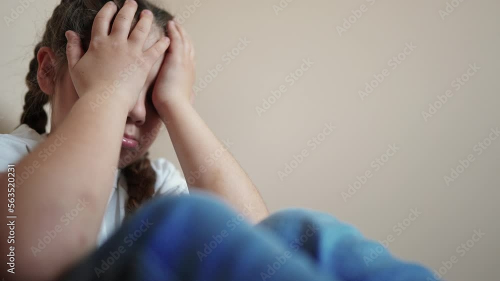 sad girl sitting in the corner crying a covered her face with her hands. family violence abuse ...