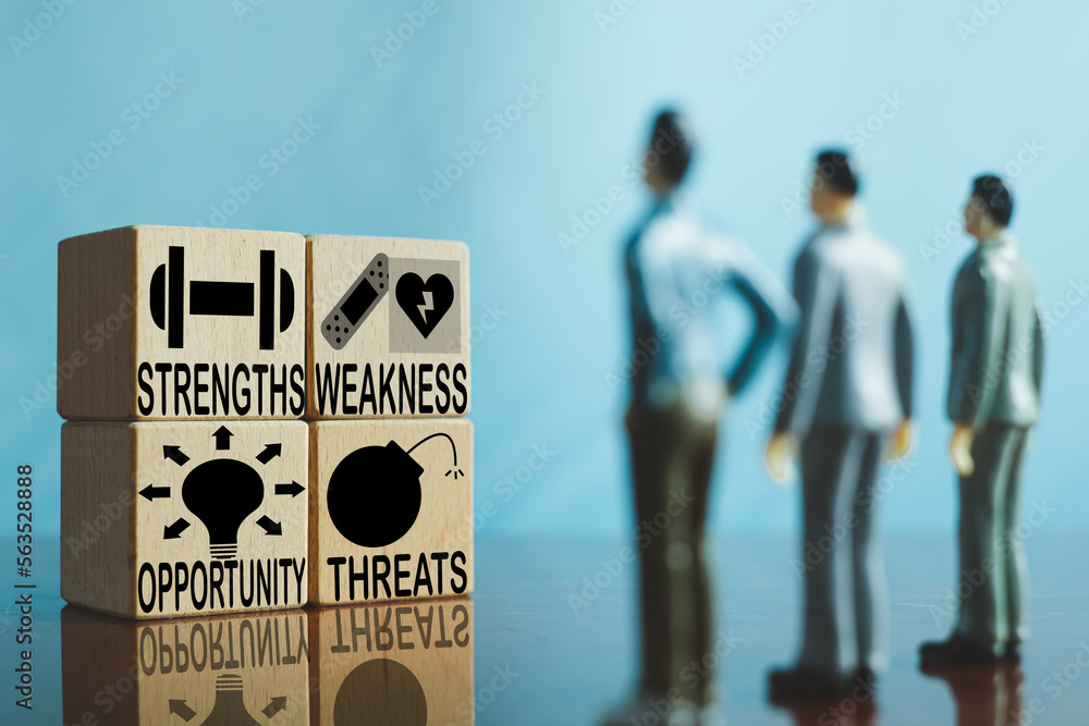 A business people group focus on wooden cubes with SWOT(Strengths ...