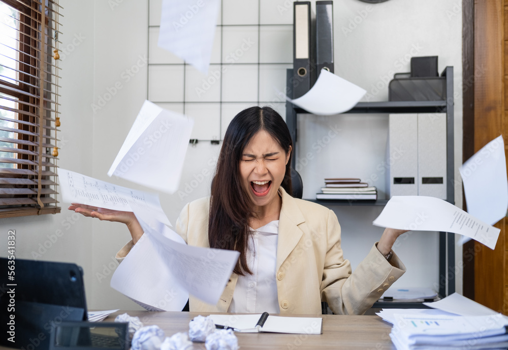 Young asian business woman with too much work. Stock Photo | Adobe Stock