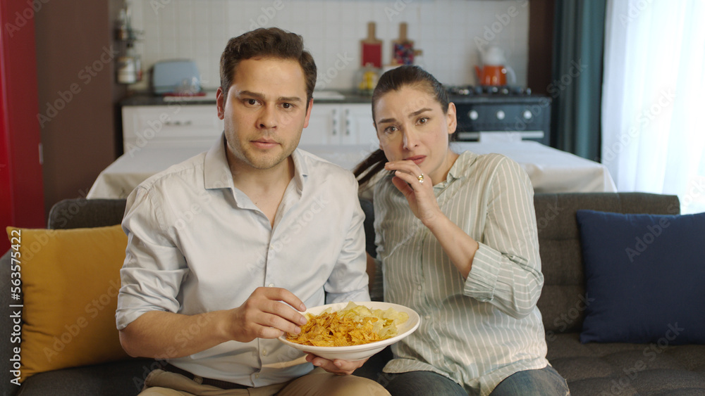 Two couples in love are watching an exciting movie with interest in ...