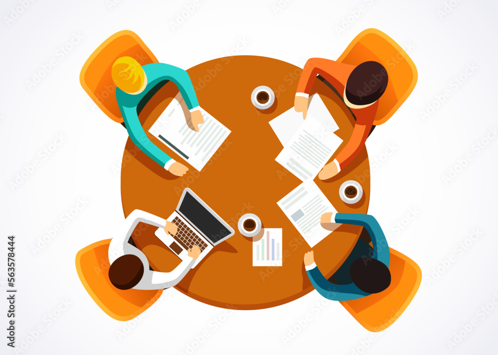 Team works together around a round table. Teamwork, brainstorming ...