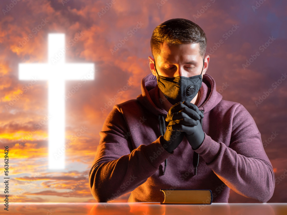 Patient prays to God. Christian man in black respirator. Guy in medical ...