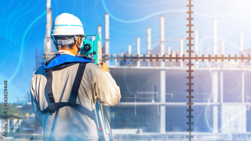 Man surveyor controls construction of building. Guy aims geodetic ...