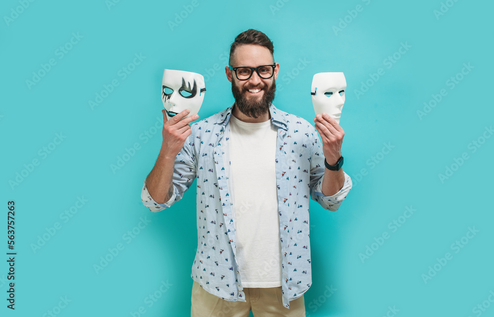 Portrait of a man with a beard covering his face with a white mask ...