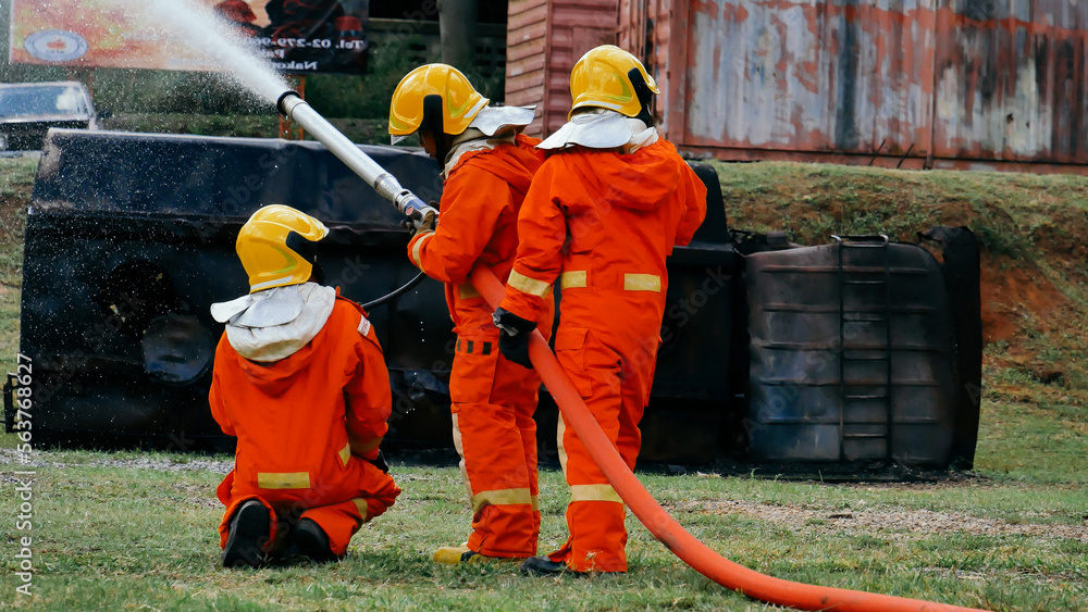 Firefighter Rescue team training in fire fighting extinguisher ...