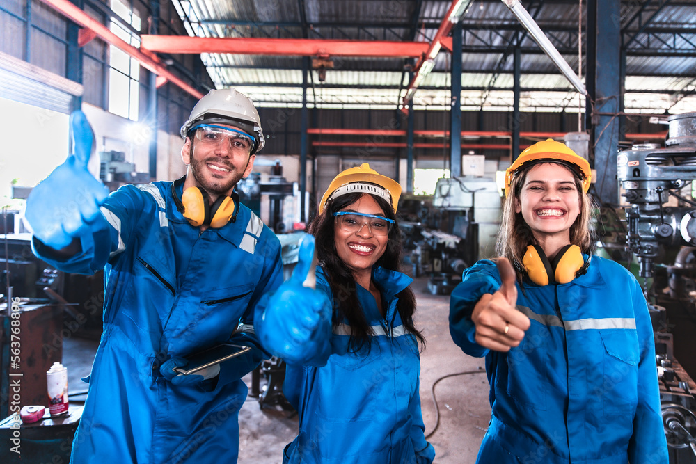 Young people worker in protective uniform operating machine at factory ...