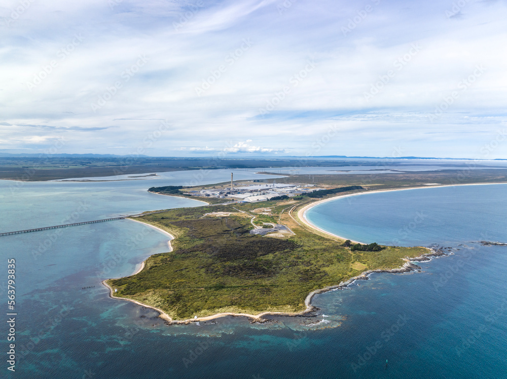High angle aerial drone view of Tiwai Point peninsula at the entrance ...