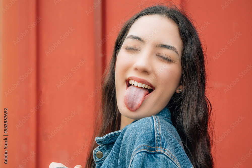 funny young woman sticking out her tongue in amused expression on the ...