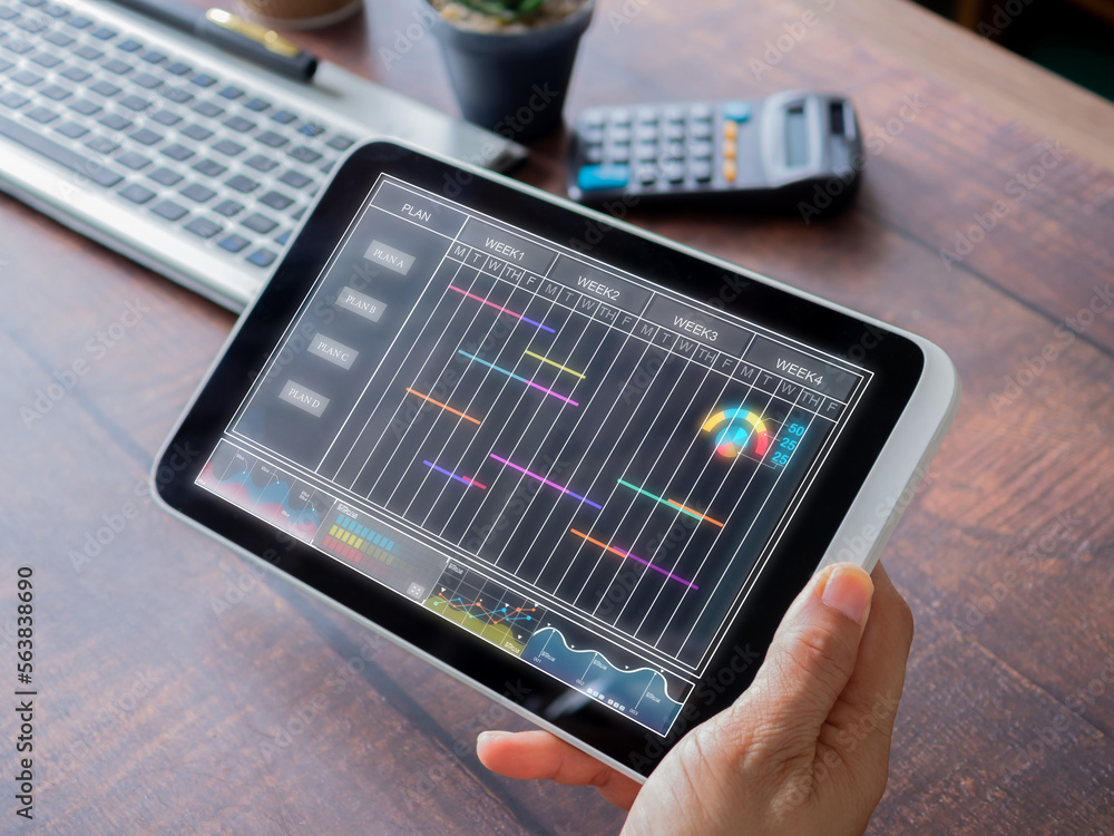 Businessman looking at analytics and data management system to make ...