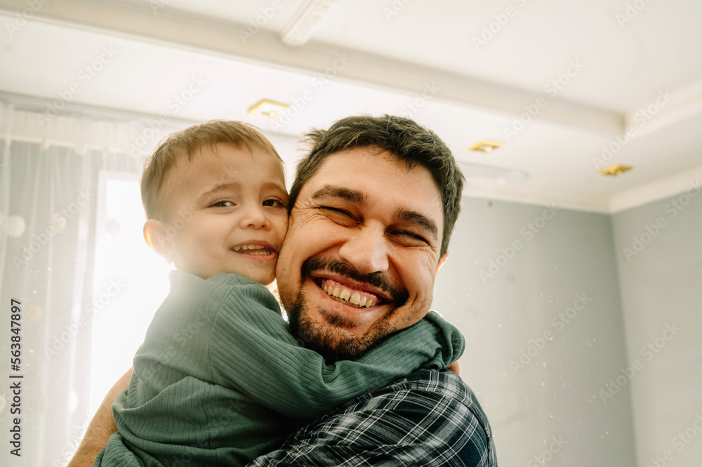 Happy father hugging son at home Stock Photo | Adobe Stock