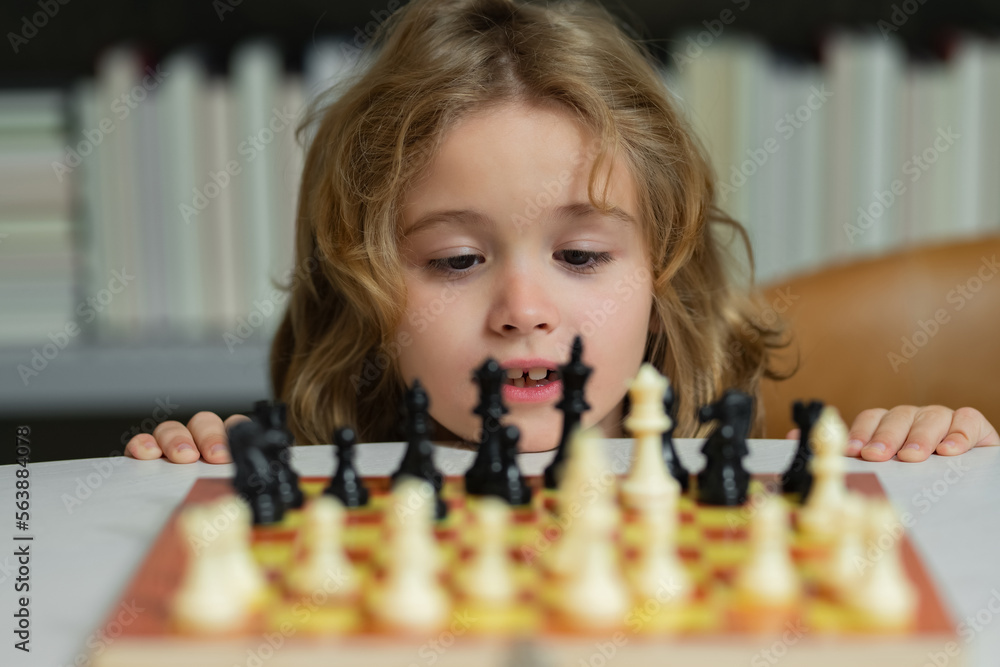 Little child play chess. Kid playing board game. Thinking child ...