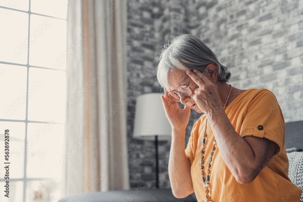 Sad depressed middle aged mature woman sitting alone at home touching ...