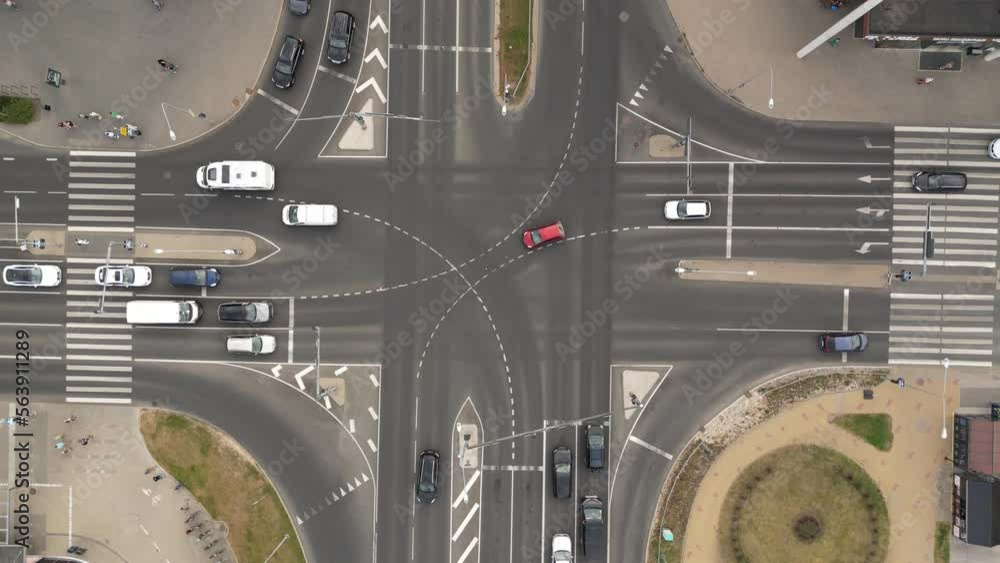 Top down aerial of cars drive at cross road. Heavy traffic in downtown ...