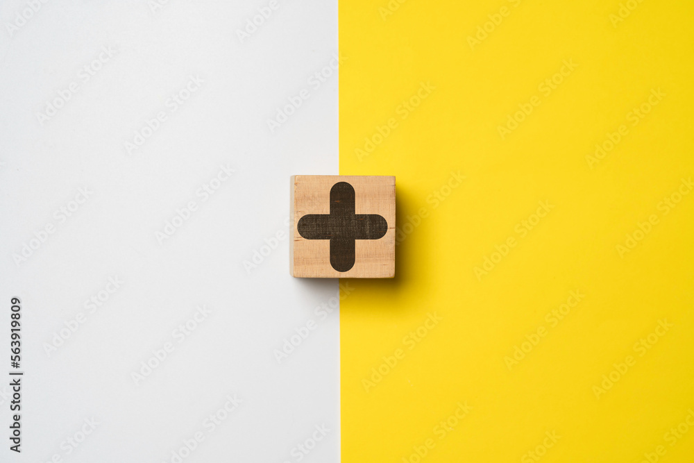 Plus sign on white and yellow background for positive thinking mindset ...