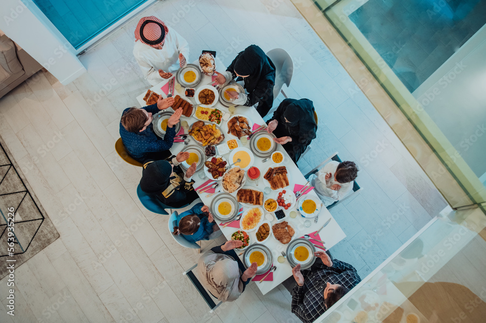 Top view of Muslim family having Iftar dinner drinking water to break ...