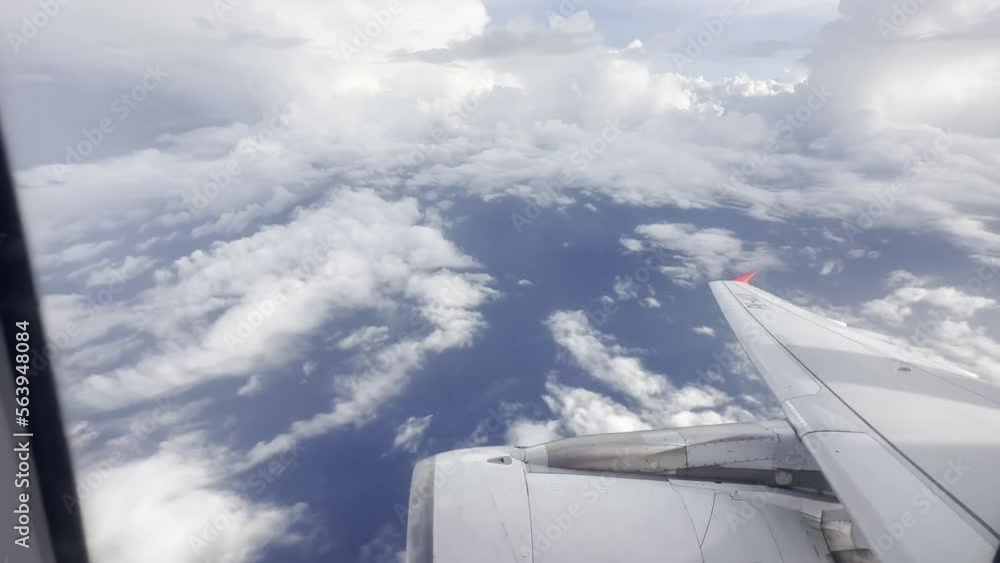 Airplane flight. Wing of an airplane flying above the clouds with ...