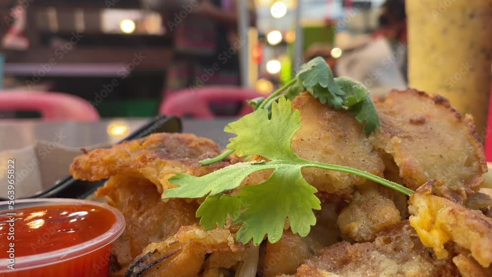 Traditional Thai street food dish close up shot on table with blurred ...