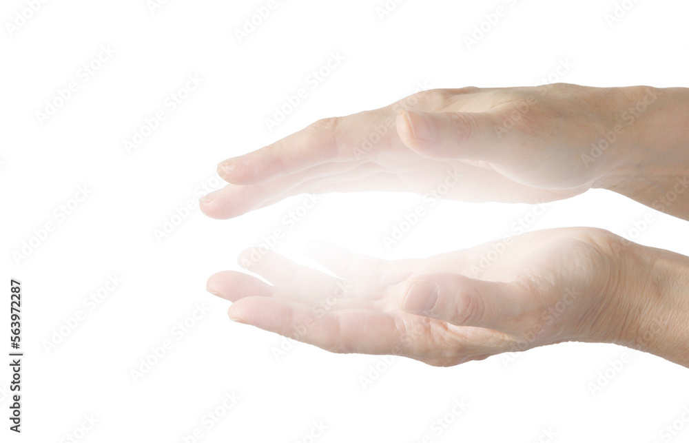 Female healer with bright white healing energy between parallel hands ...