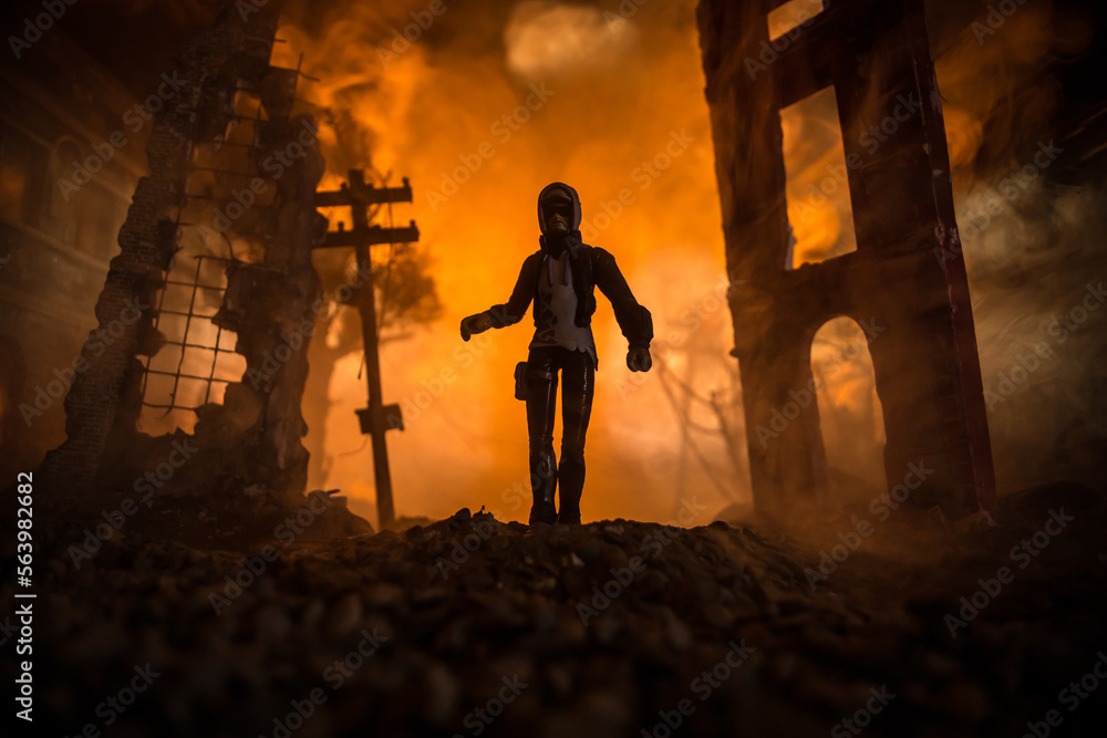 Foto de Artwork decoration. A man standing on a road of burnt up city ...