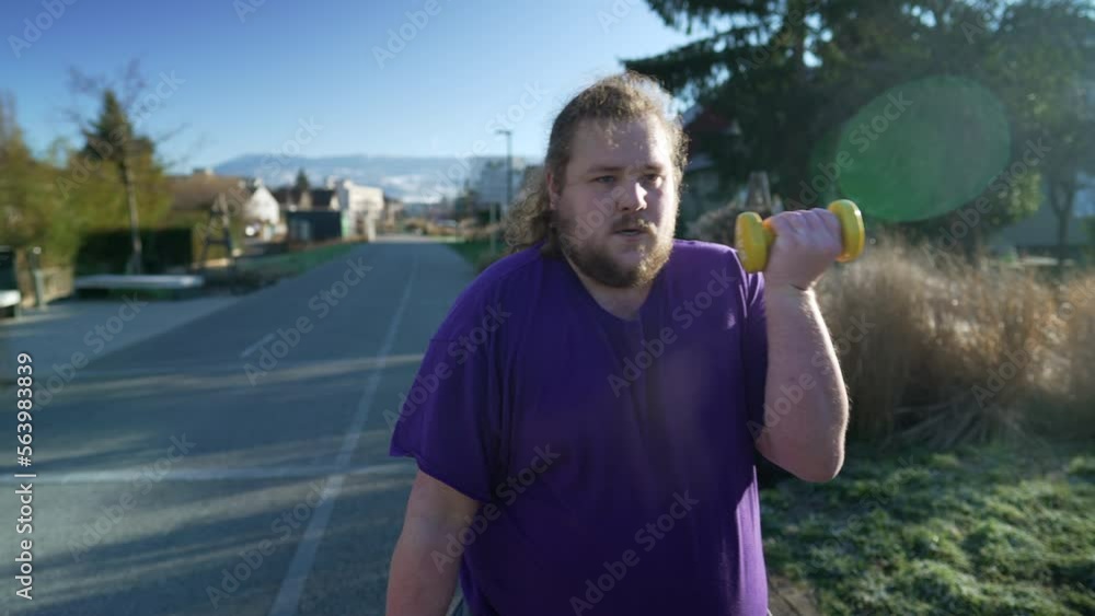 A young fat man getting back into shape building strength. Motivational ...