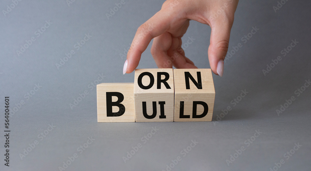 Born and Build symbol. Businessman hand turns wooden cubes and changes ...