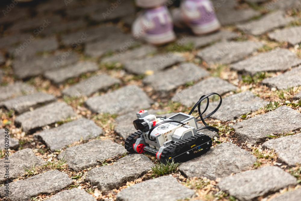 Lego Mindstorms caterpillar rover robot on the granite bricks sidewalk ...