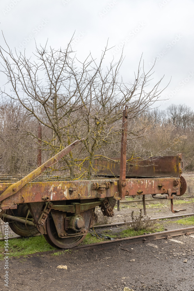 Old rusty industrial freight wagon in an abandoned train station. Train ...