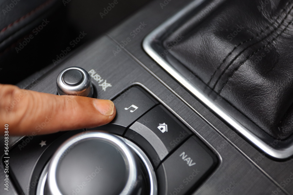 Driver turning button of muisc in car Stock Photo | Adobe Stock