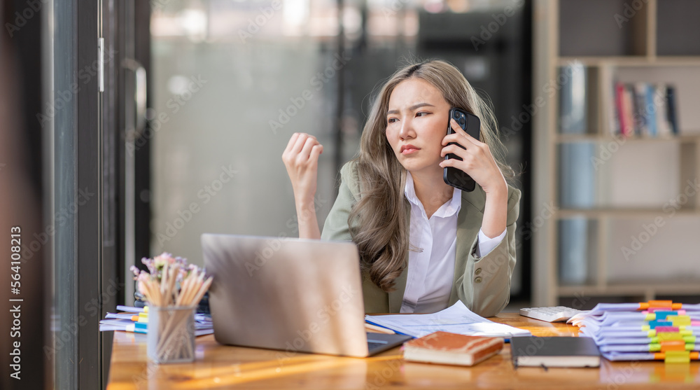 Bored Young business Asian woman sitting at her workplace at the office ...