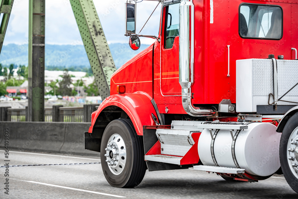Bright red classic bonnet big rig semi truck day cab tractor running on ...