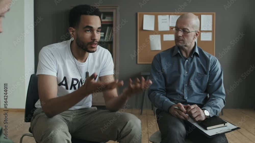 Zoom out of modern young military man suffering PTSD finishing his ...