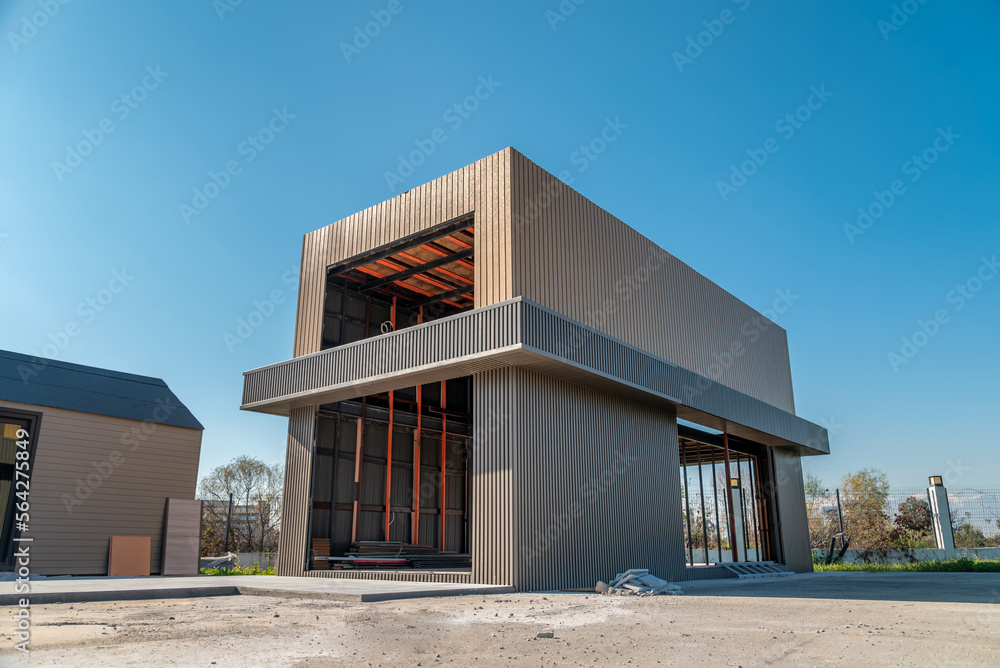 Newly built metal framed building with siding. Construction of a new ...