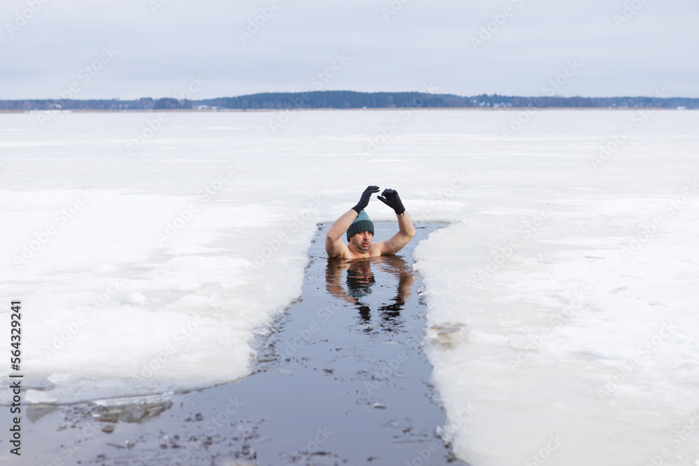 Winter swimming. Woman in frozen lake ice hole. Swimmers wellness and ...