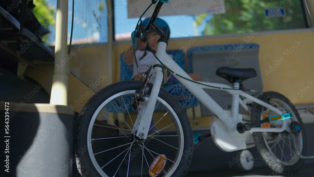 Little boy riding public bus transportation wearing helmet and holding ...