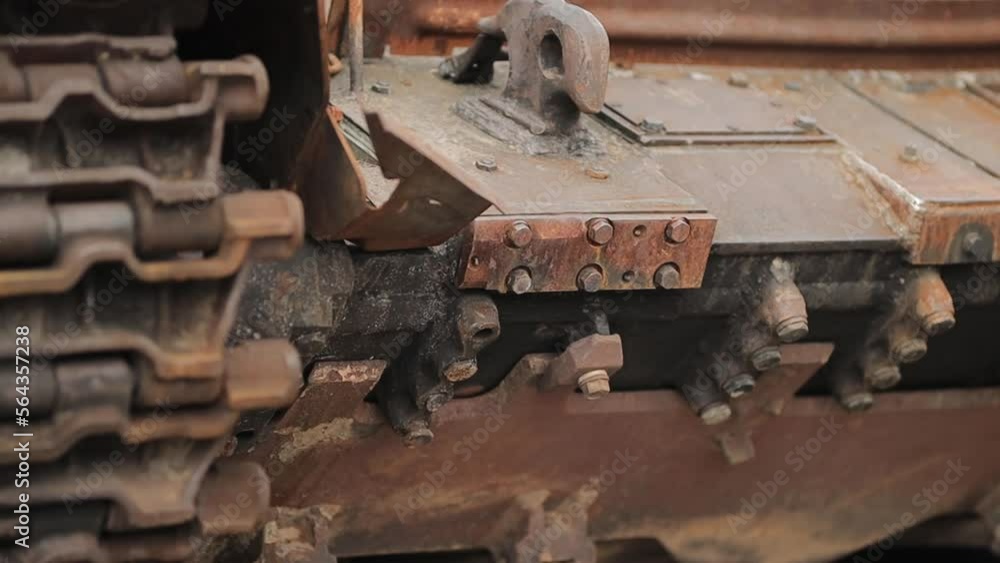 caterpillars of a burned-out Russian tank. Side view of a tank track on ...