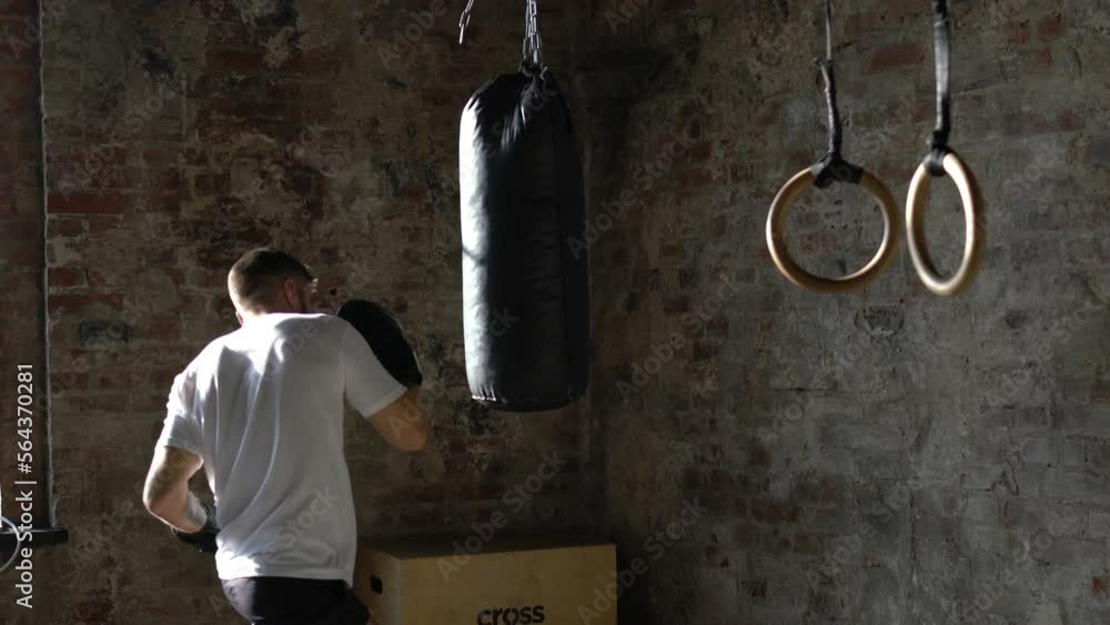 Handsome sportsman spending time in gym during boxing workout for ...