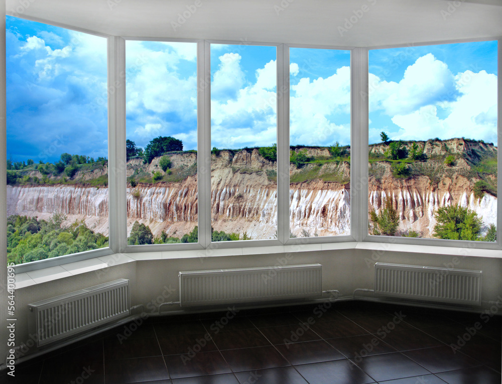 Panoramic window overlooking sandy cliff. View of sand pit from window ...
