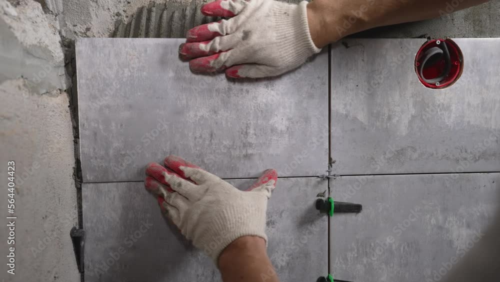 The process of laying tiles. Construction, renovation, apartment ...