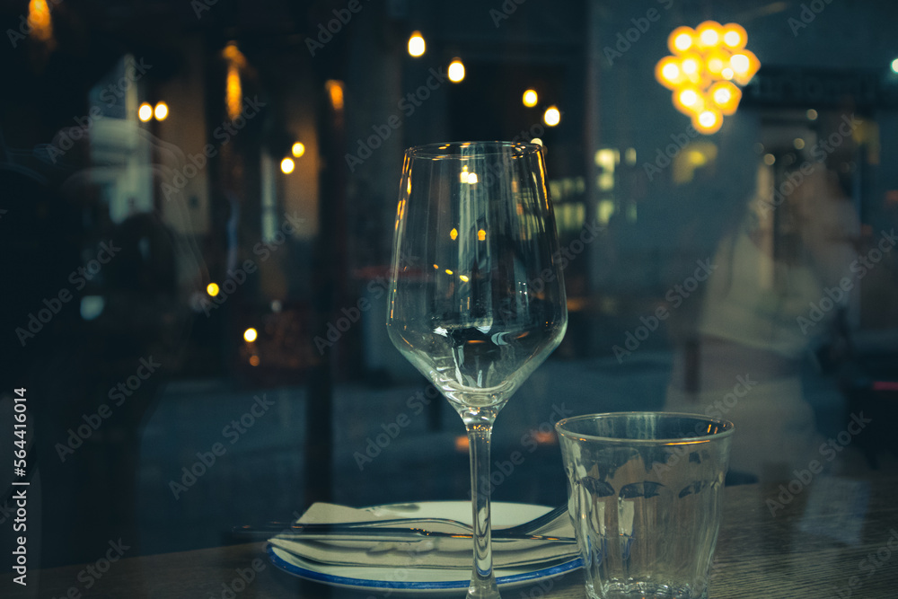 Empty wine glass, water glasses standing on a table on dark blue background. Luxury elegant ...