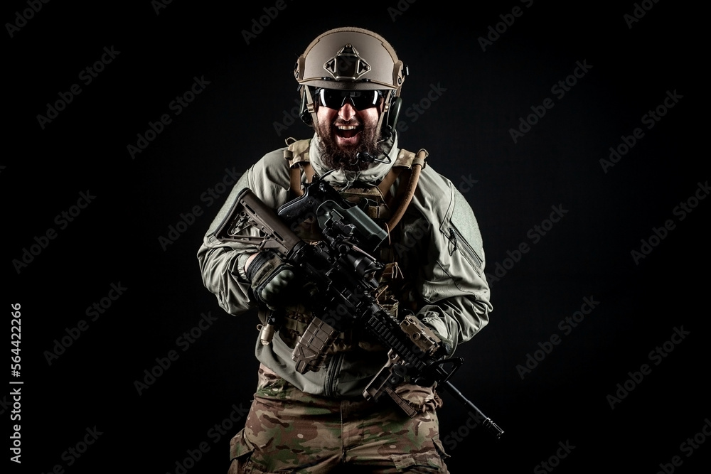 angry soldier in uniform with a rifle screaming at night, commando in ...
